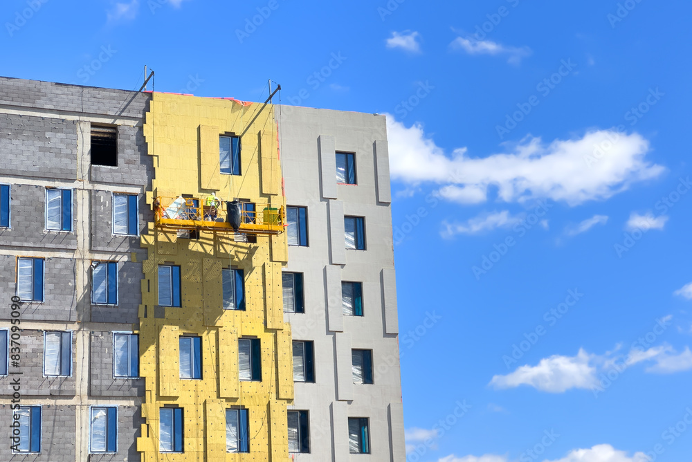 Facade Insulation. Suspended cradle mobile scaffolding platform for ...