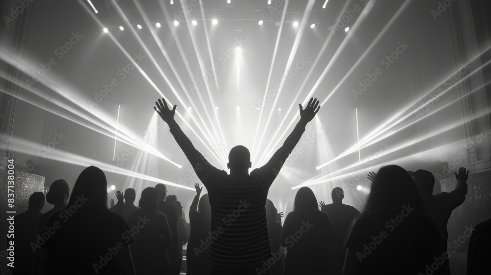 black and white image of people silhouette with raised hands at ...