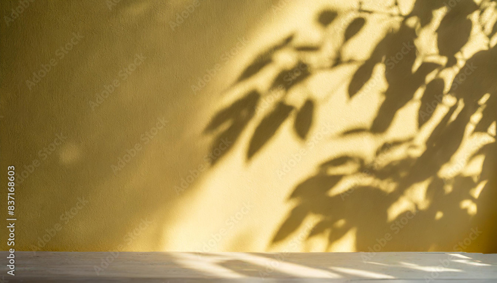 light background of shadows from plant leaves on a delicate light ...