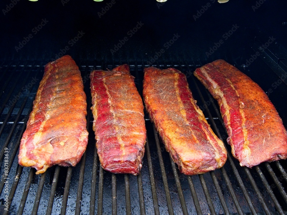 Smoking pork side ribs on a pellet grill; four racks of ribs in a grill ...