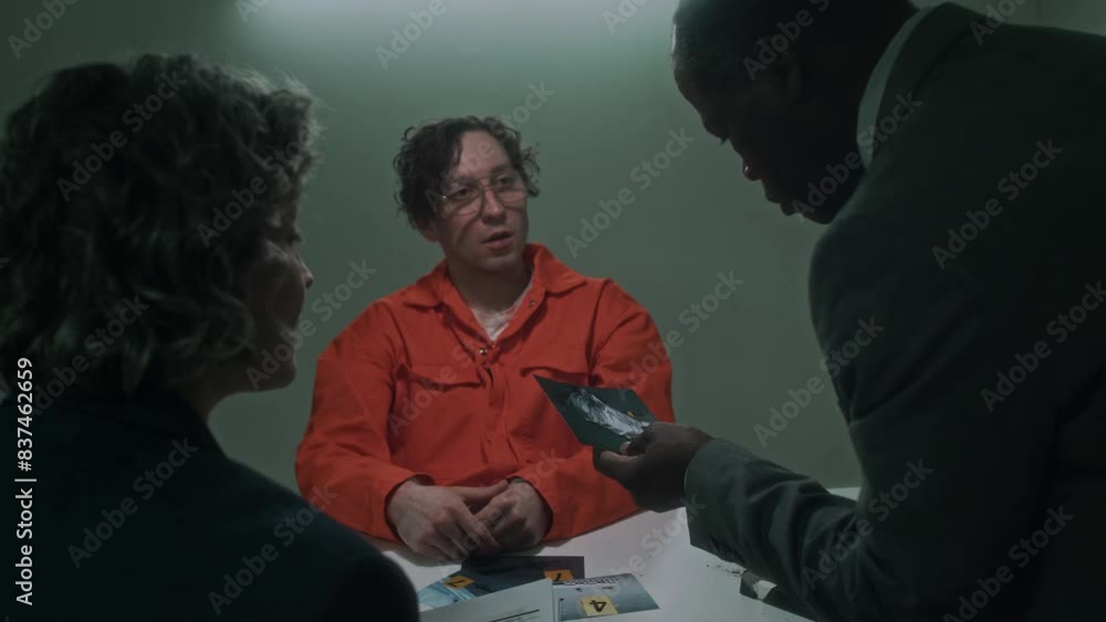 Medium rear shot of African American federal agent questioning ...