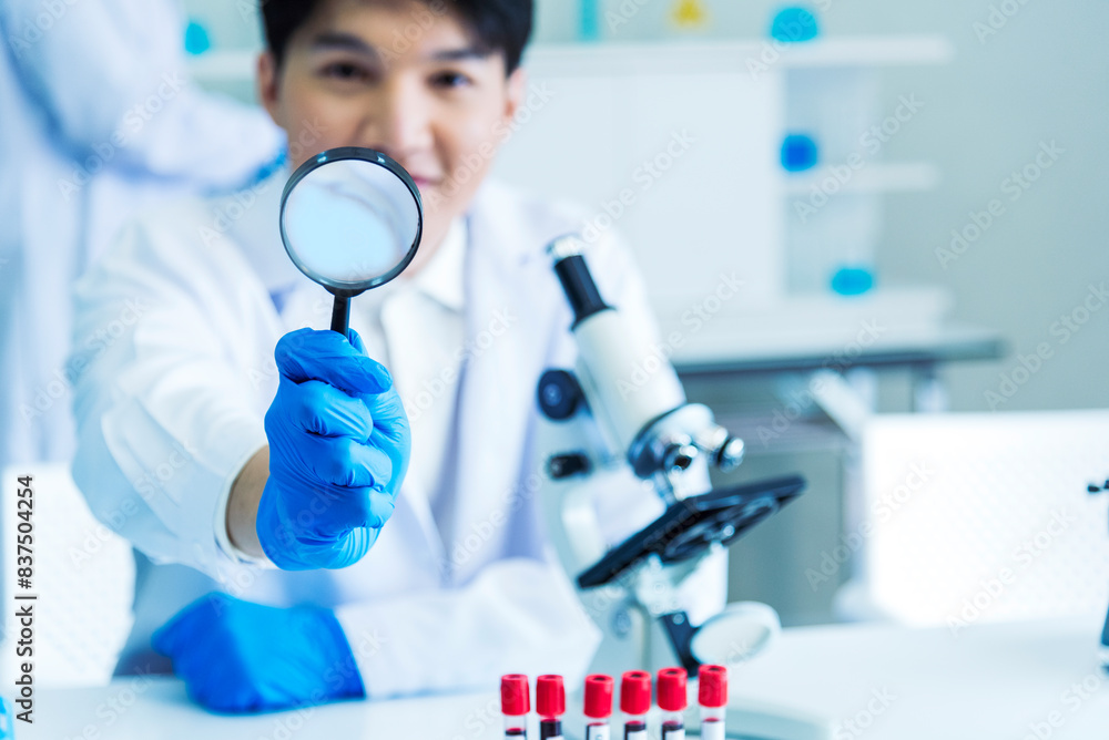 Scientist man look into Microscope research in science laboratory. Asian scientist look at ...