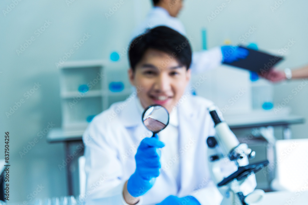 Scientist man look into Microscope research in science laboratory ...