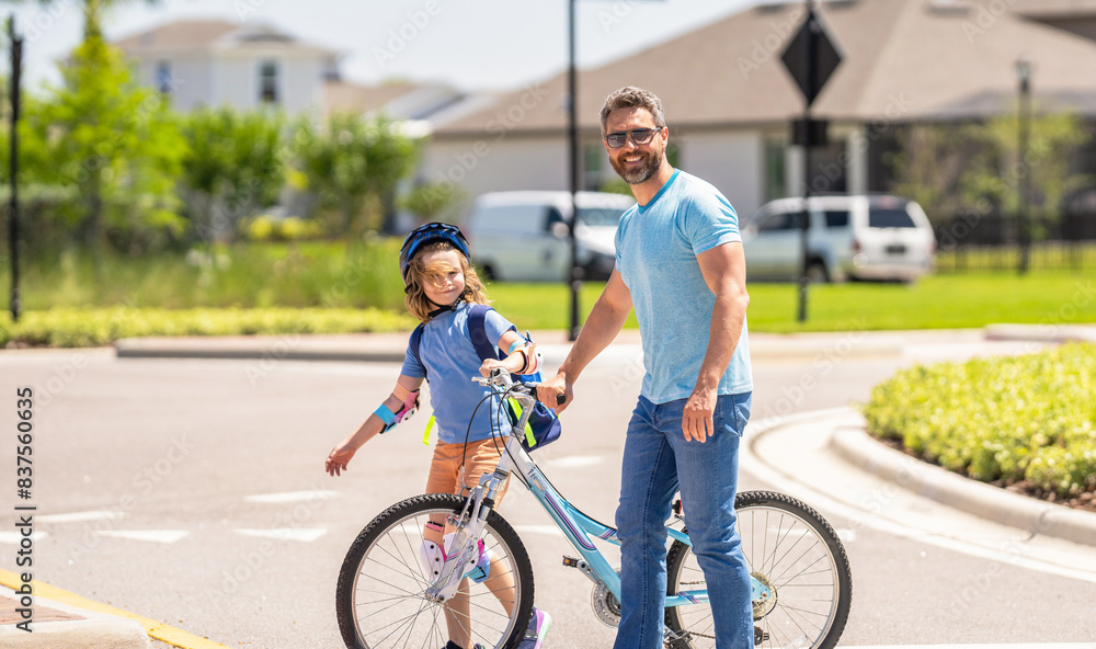 father and son on bicycle at fathers day. active father setting a ...