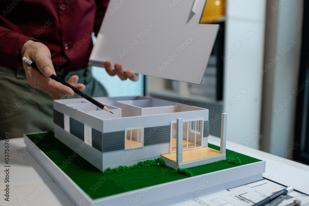 an architect is working on blueprint to finish in on time, architect is ...