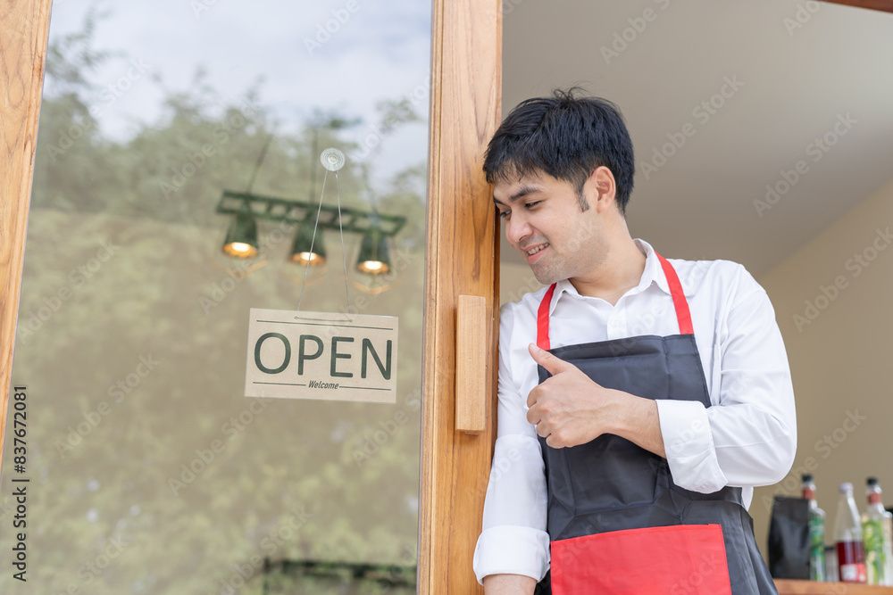 Business owner thumbs up to show his readiness to welcome customers ...