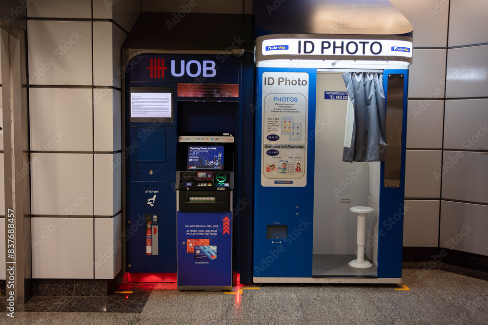 SINGAPORE - APRIL 19, 2022: UOB ATM machine next to ID Photo self ...