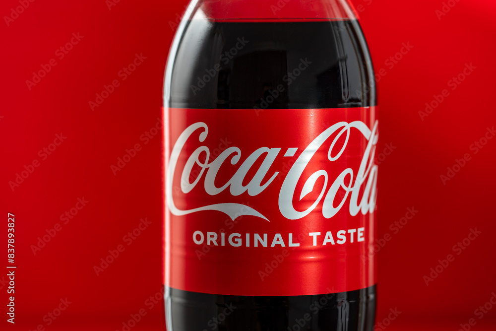 Label and trademark on plastic bottle of Coca-Cola on red background ...