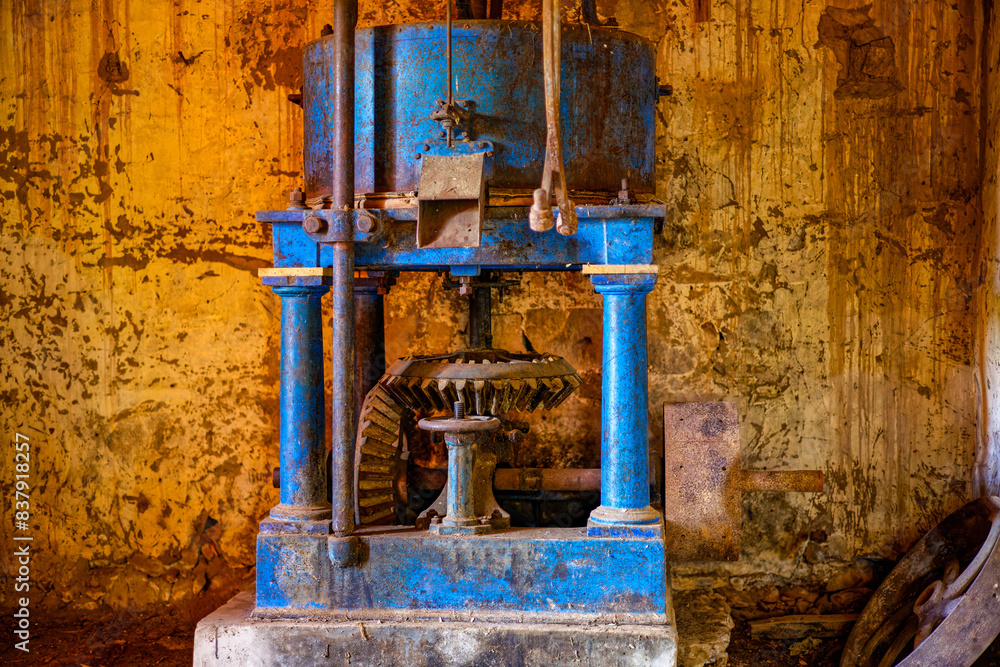 Ancient gear-driven mill that used to grind grains in shed using a ...