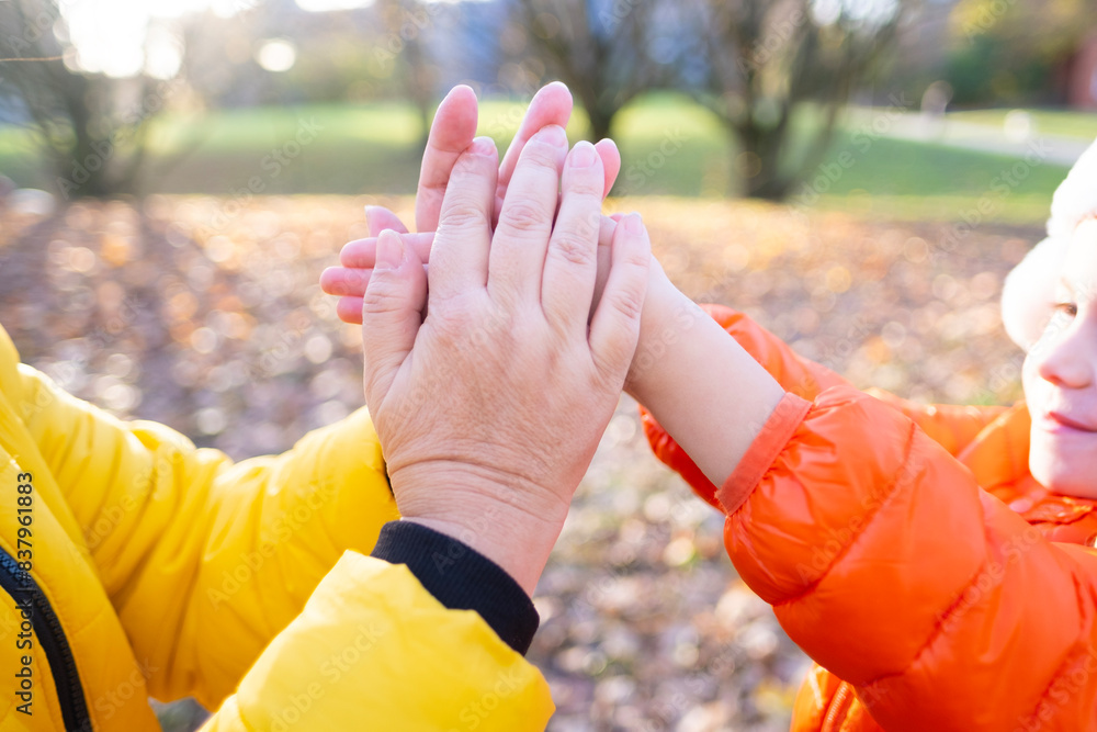 child's hands frozen, mother warms, rub cold palms girl on walk ...