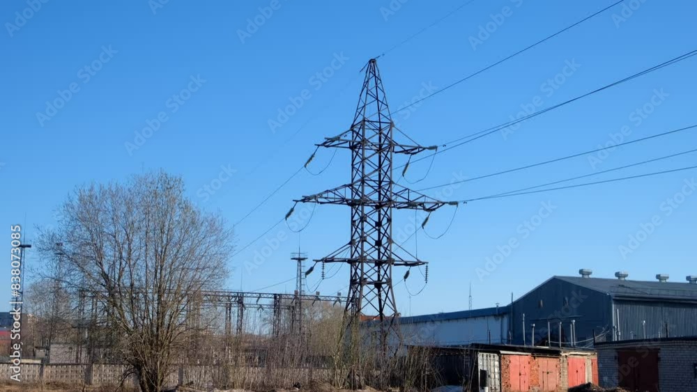 High voltage electric tower on sunny sky background in village ...