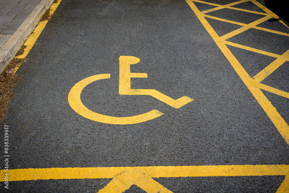 Yellow handicap parking symbol on asphalt, highlighting accessibility ...
