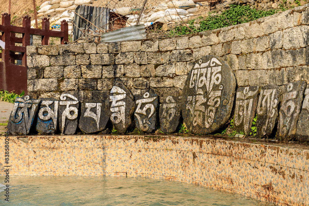 Nepal sacred stones mani with mantra written and carved on the surface ...