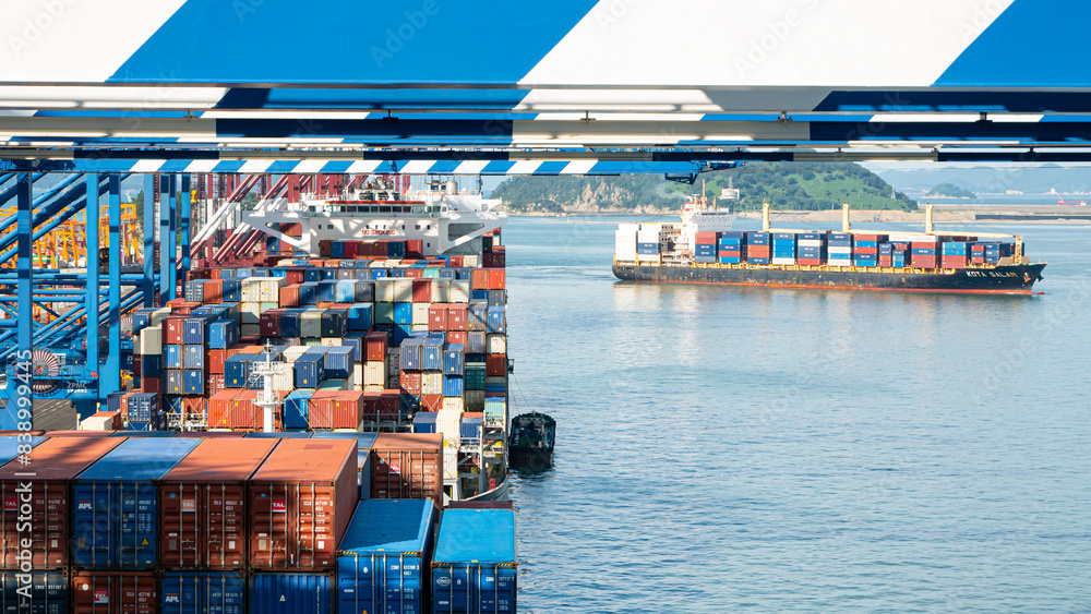 Busan, South Korea - 10.01.2023: Small feeder container vessel approach ...