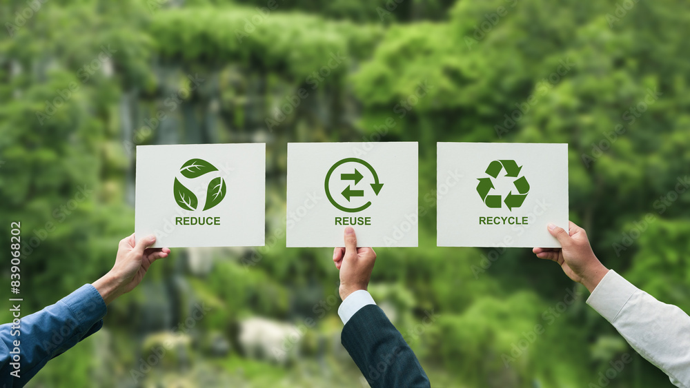 Businessman's hand holding paper with symbols of reduce, reuse and ...