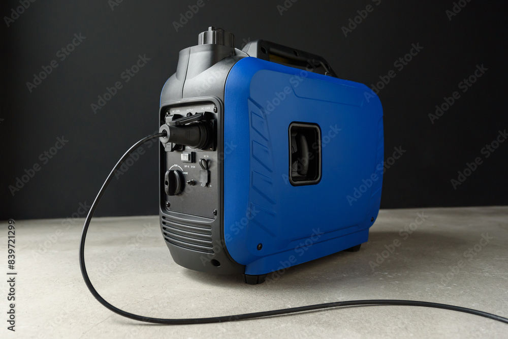 Connected generator. A modern blue portable gasoline inverter generator ...