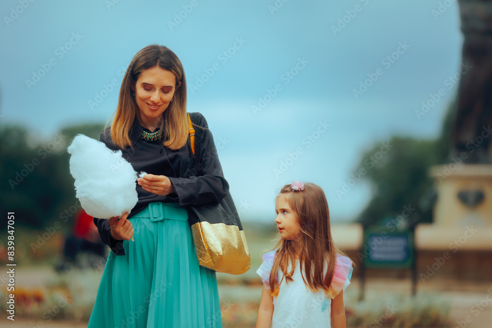 Mother and Daughter Waking in the Park Eating Cotton Candy. Cheerful ...