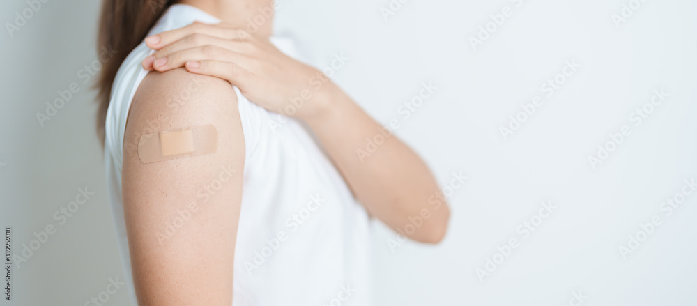 Woman with bandage after receiving vaccine. Vaccination and ...