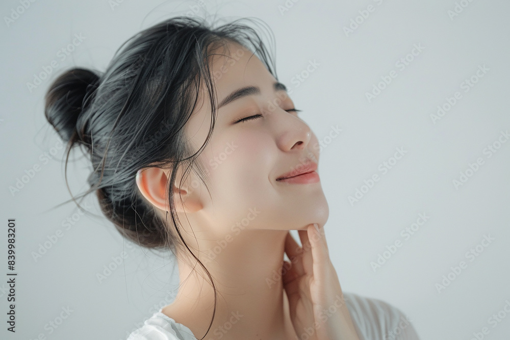 Beautiful Japanese woman smiling and touching her face with a white ...