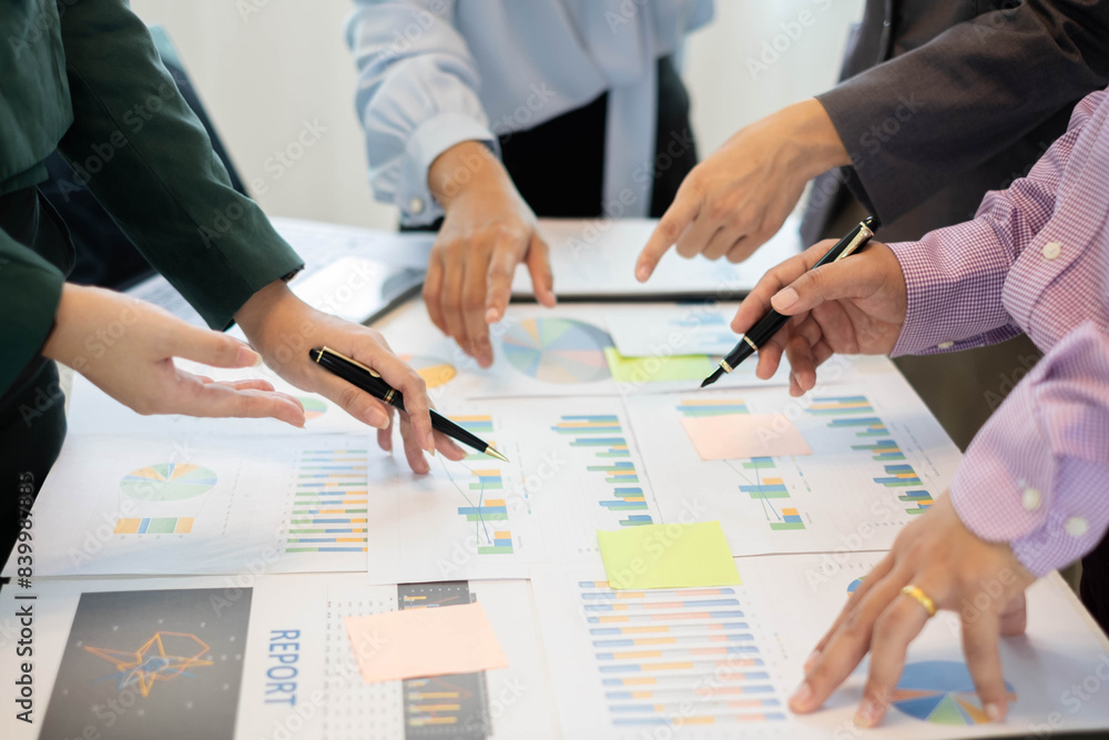 Business leaders talk about charts, financial graphs showing results ...