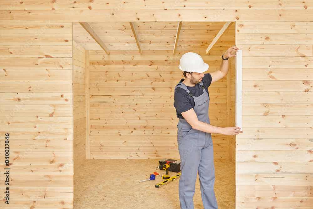 Construction man, builder man construct new wooden home, tiny house ...
