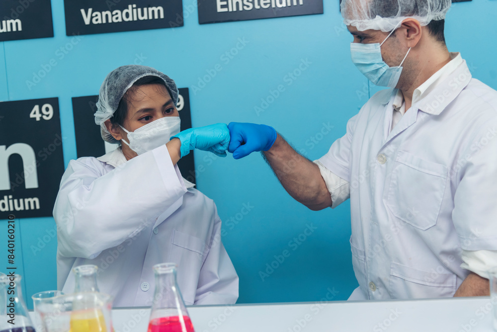 Two caucasian scientist men woman fist bump team partner shake hands ...