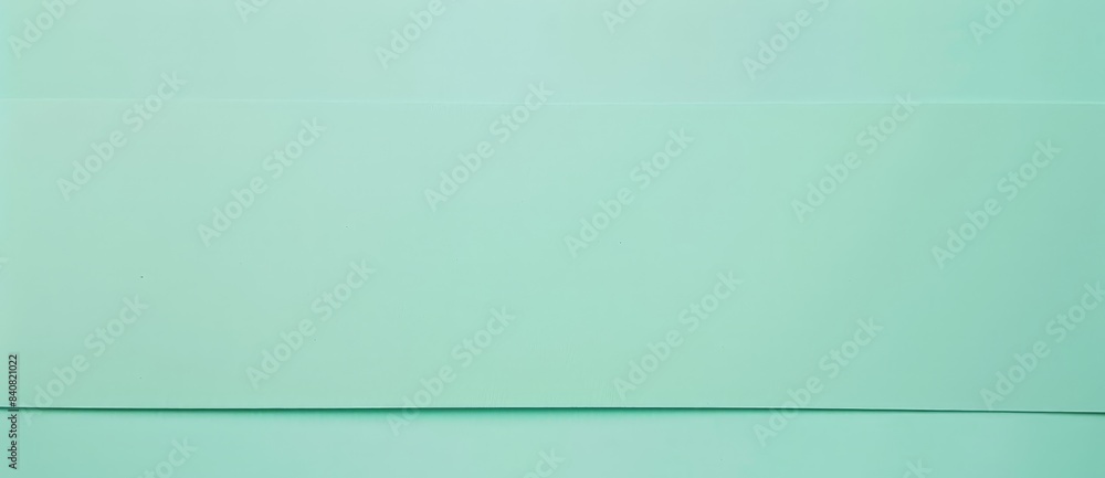 Minimalist light green background featuring a blank horizontal paper ...