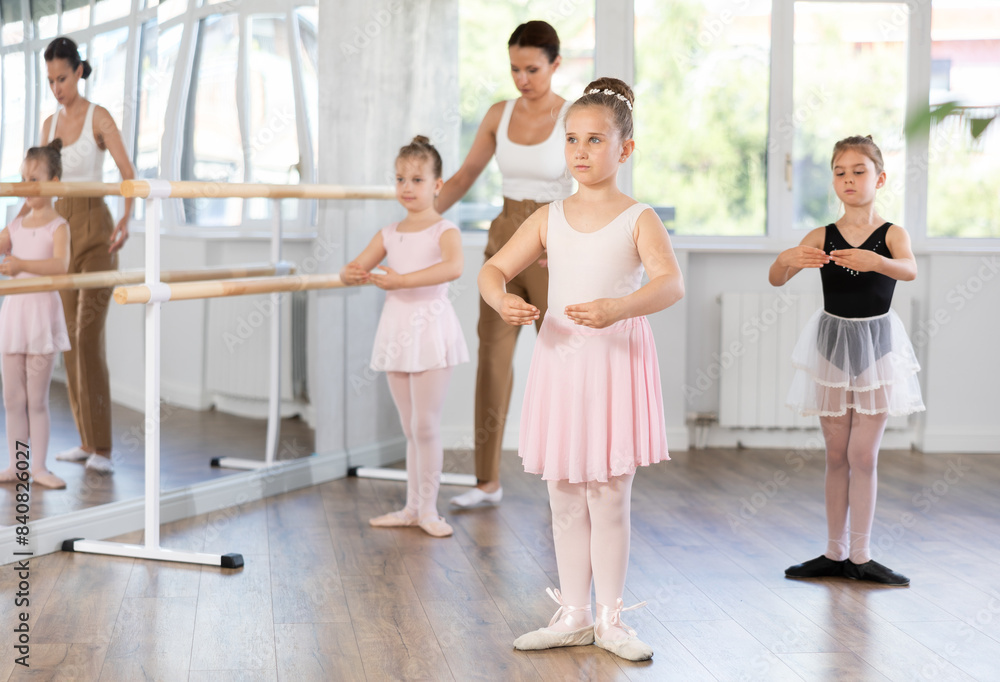 Female teacher conduct training, performs correction of pose in first ...