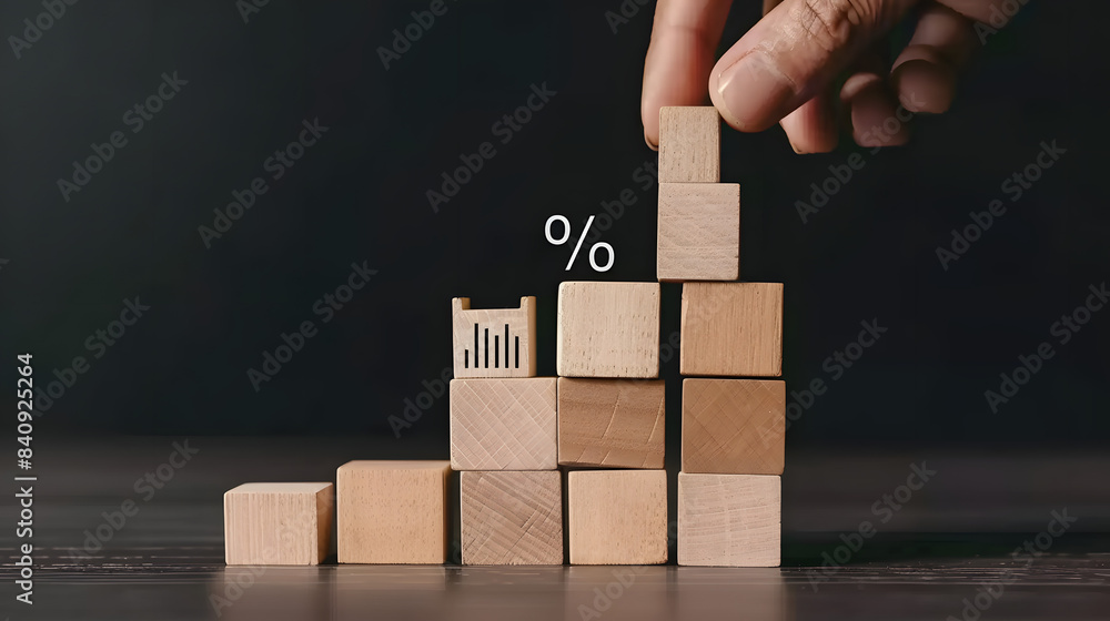 Hand adding wooden blocks with % sign to graph bar chart growth concept ...