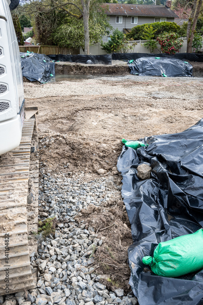 Beginnings of a new house, foundation excavation started with backhoe ...