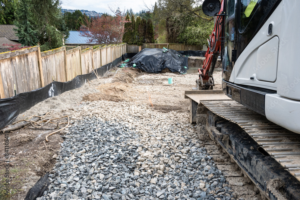 Beginnings of a new house, foundation excavation started with backhoe ...