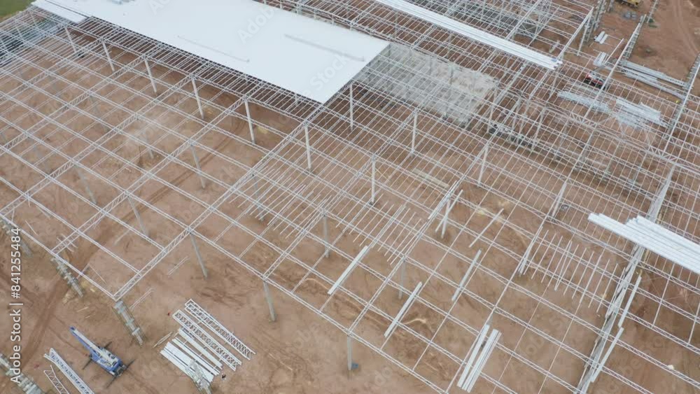 Aerial view of busy industrial under construction site workers working ...