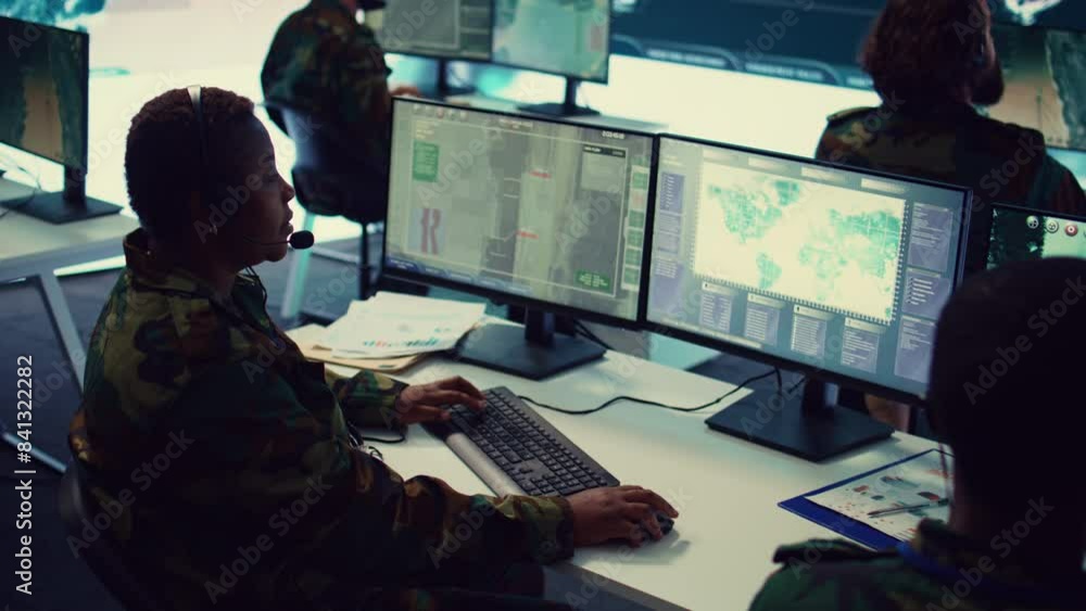 Woman army officer operates on gps surveillance footage to gather ...