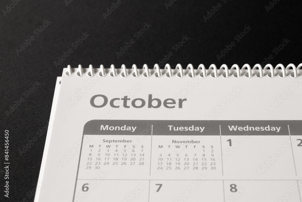 White calendar of the month of October on a black background. Planning ...