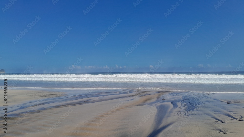 Beautiful beach with waves breaking on the rocks, Malang Modangan, East ...