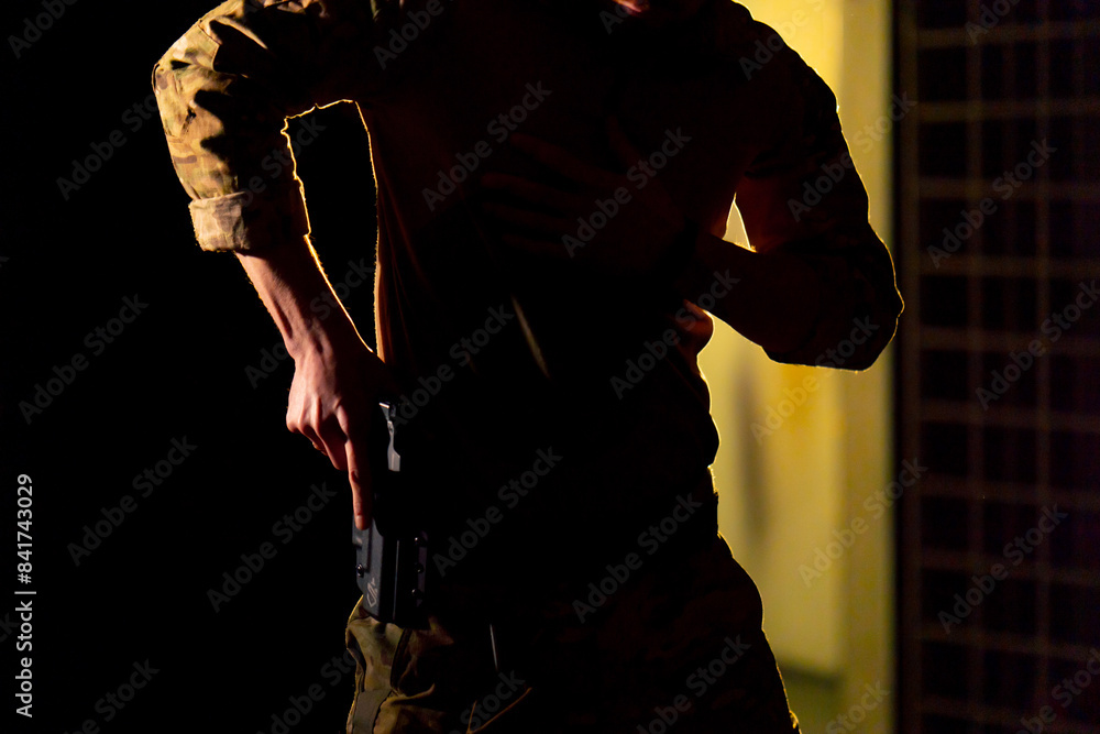 at a professional shooting range a military trainer reloading a pistol ...