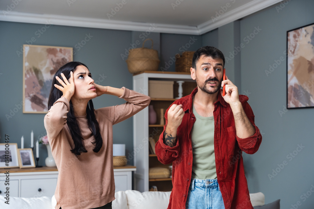 Young couple calling police to report domestic violence. Man and woman ...