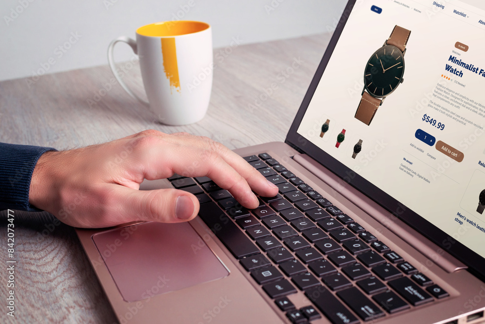 Hand typing on laptop keyboard, shopping for watches online on e ...