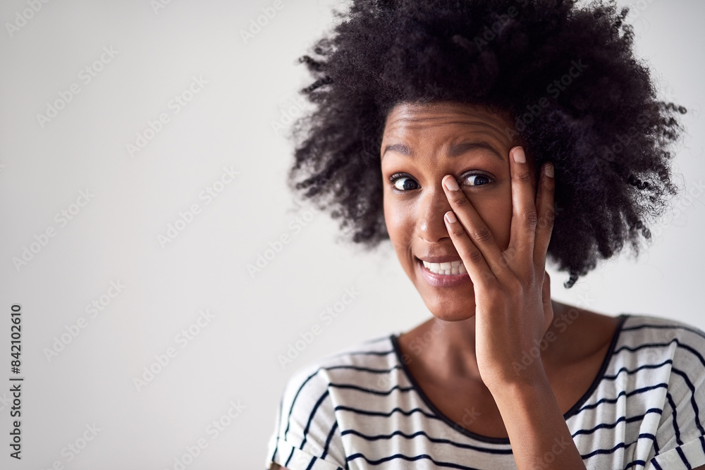 Portrait, African woman and peeking with hand over eye in studio with ...