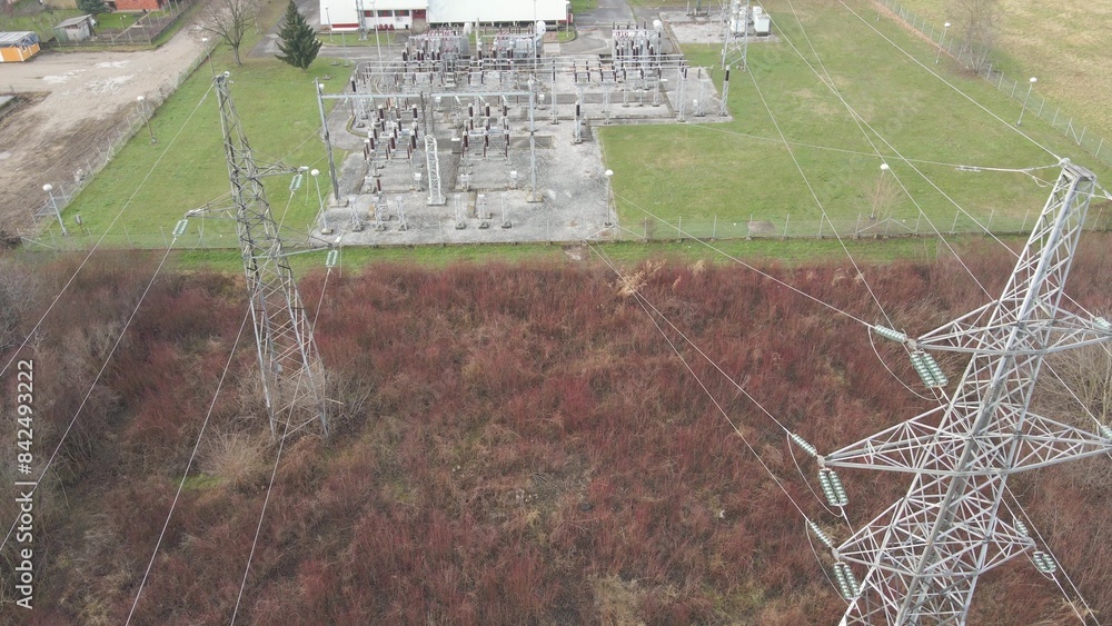 High voltage substation with tall pylons and distribution system cable ...