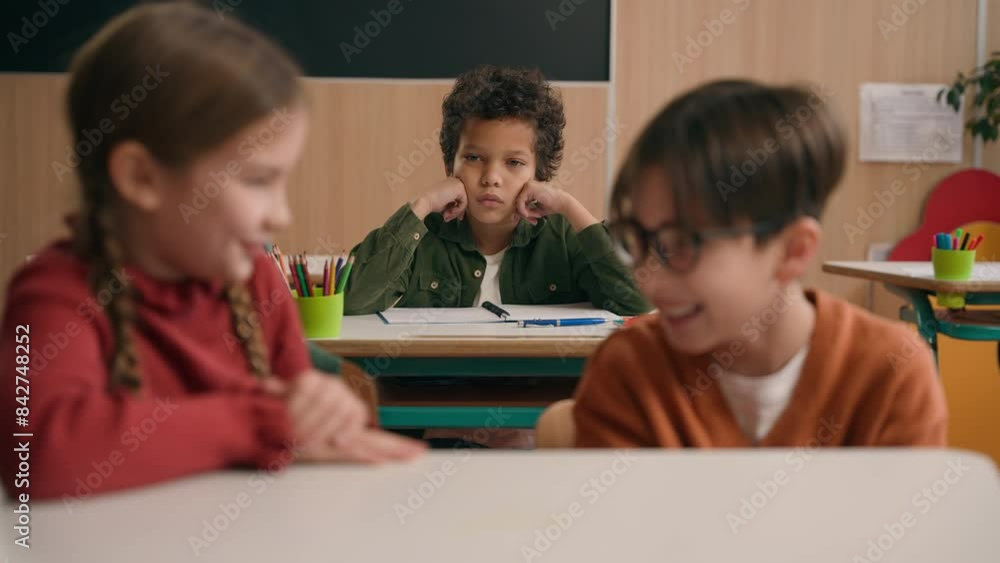 Two Caucasian children school lesson girl boy classmates laughing talk ...