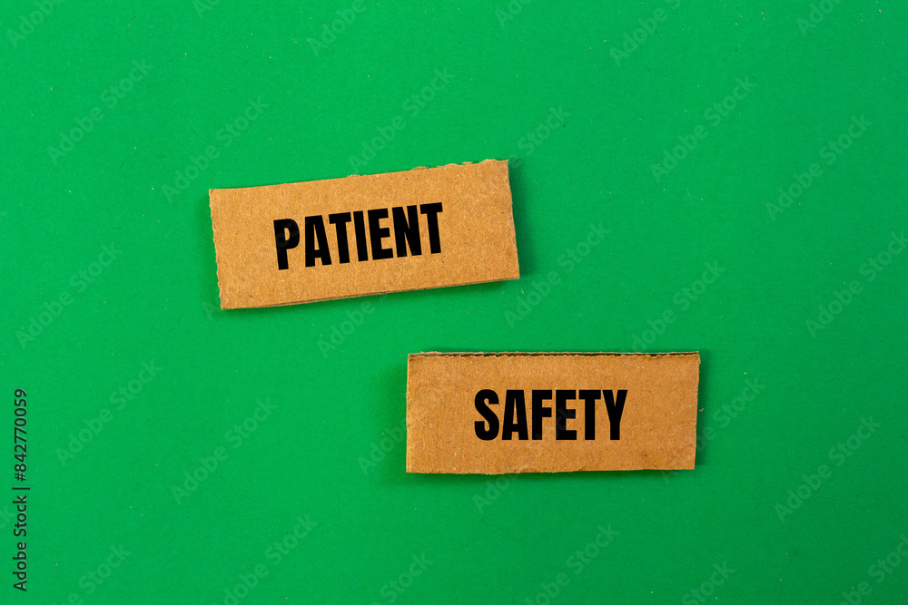 Patient safety message written on ripped cardboard paper pieces with ...