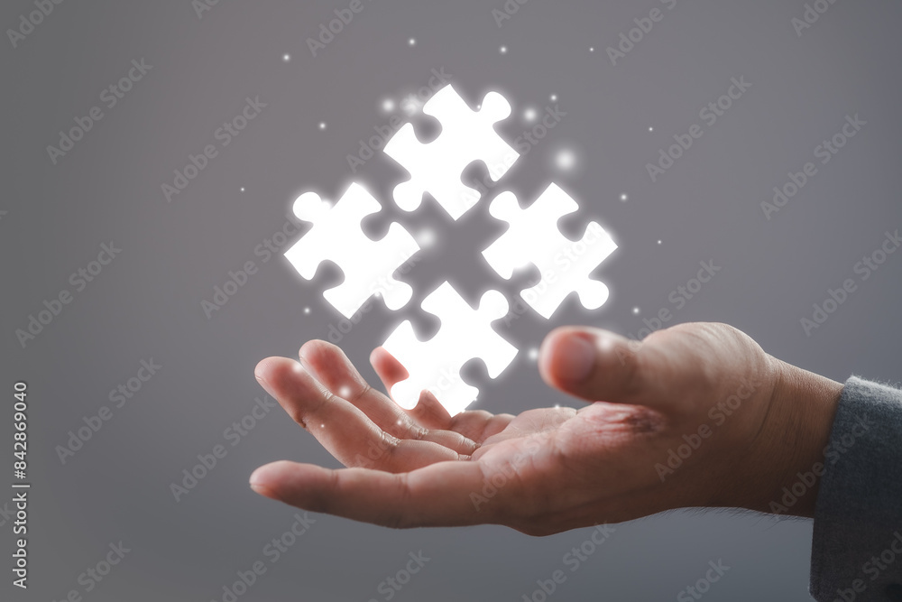 hand trying to connect puzzle piece with gray background. Jigsaw puzzle ...