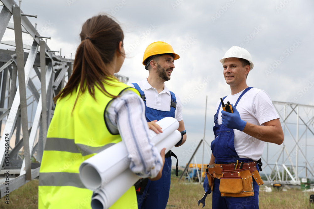 Professional engineers working on installation of electrical substation ...