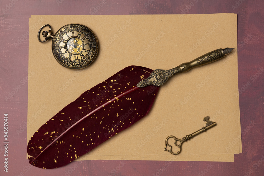 Old quill pen, old paper, vintage watch and key on a burgundy ...