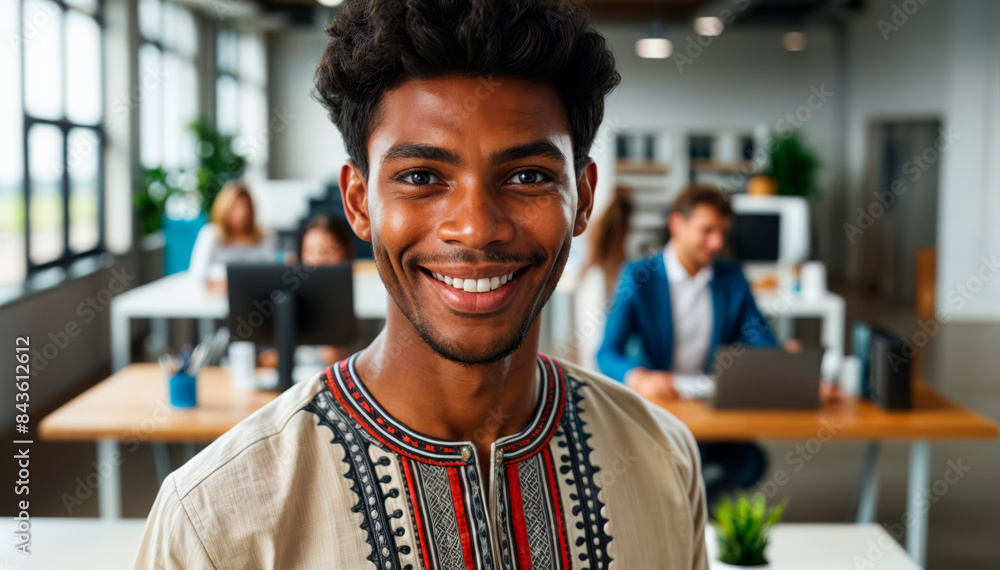 Smiling African American man in traditional attire in a modern office ...