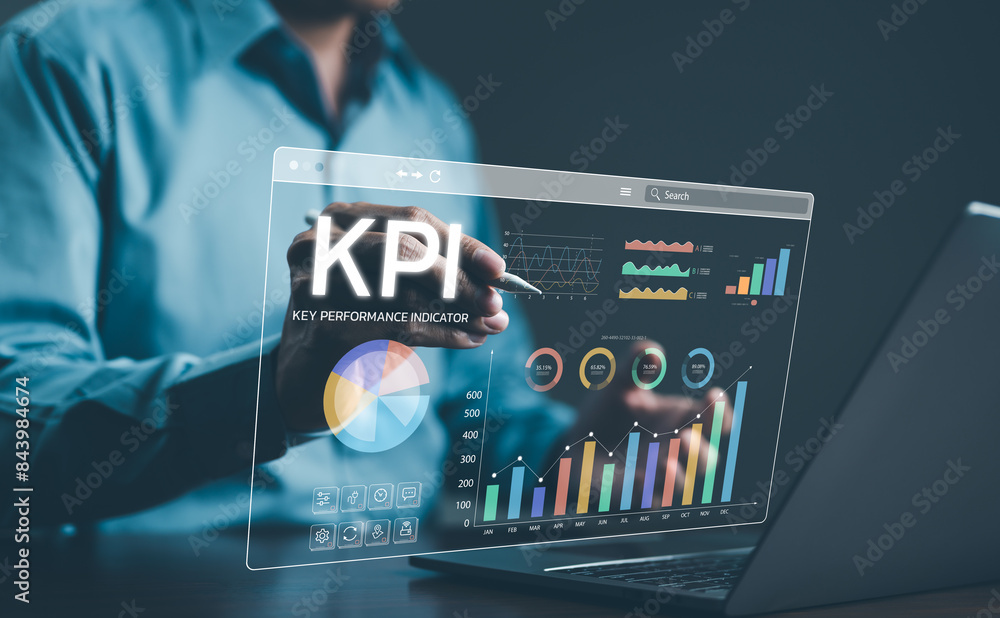 Analyzing Key Performance Indicators. Businessman using digital screen ...