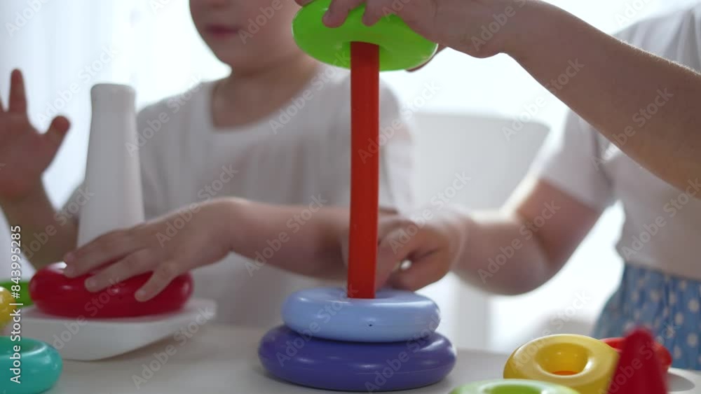 Children playing together at home. Building pyramid together. Playtime ...