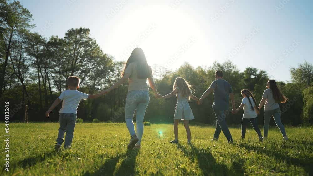 Happy family together outdoor. Parents and children holding hands in ...