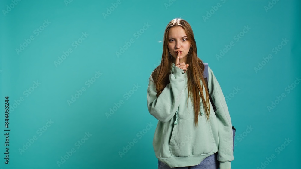 Stern woman doing shushing hand gesturing, irritated by noise, having ...